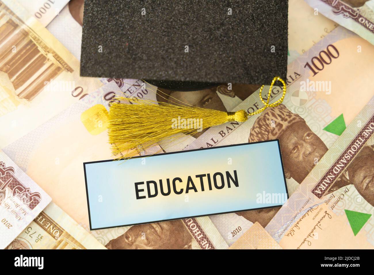 University Mortarboard academic cap on Nigerian Naira notes Stock Photo ...