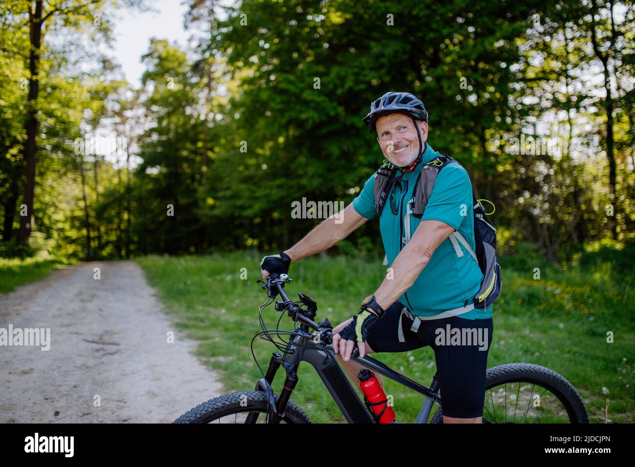 Elderly man riding bicycle bike ride exercise park cycle hi-res stock ...