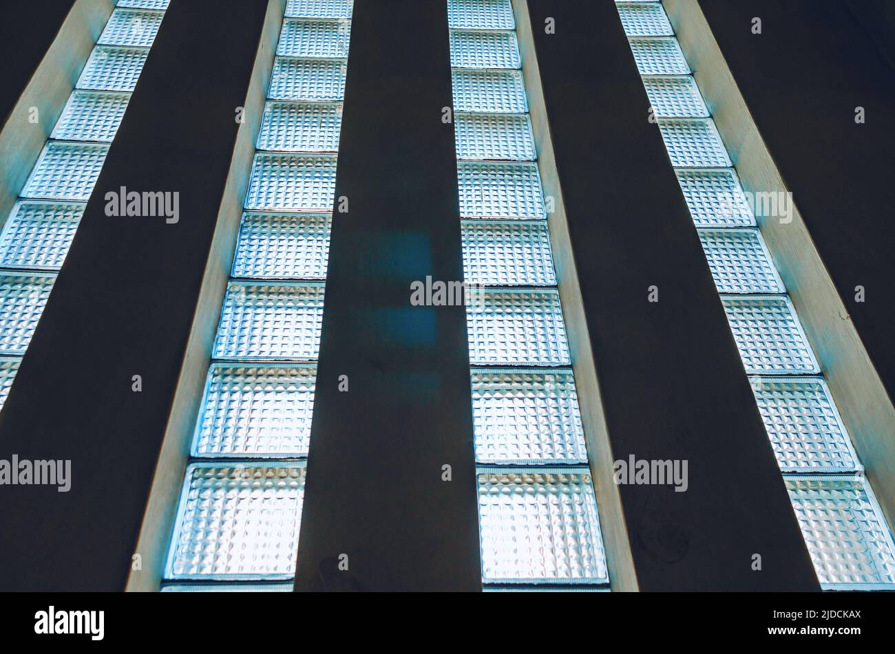 Old glass wall blocks in wall of a Soviet-style house. Scattered light ...