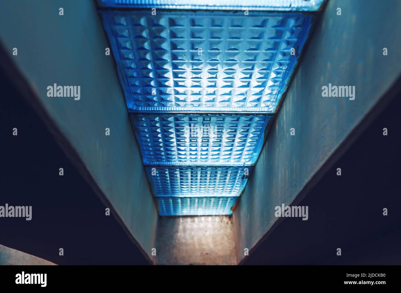 Old glass wall blocks in wall of a Soviet-style house. Scattered light ...