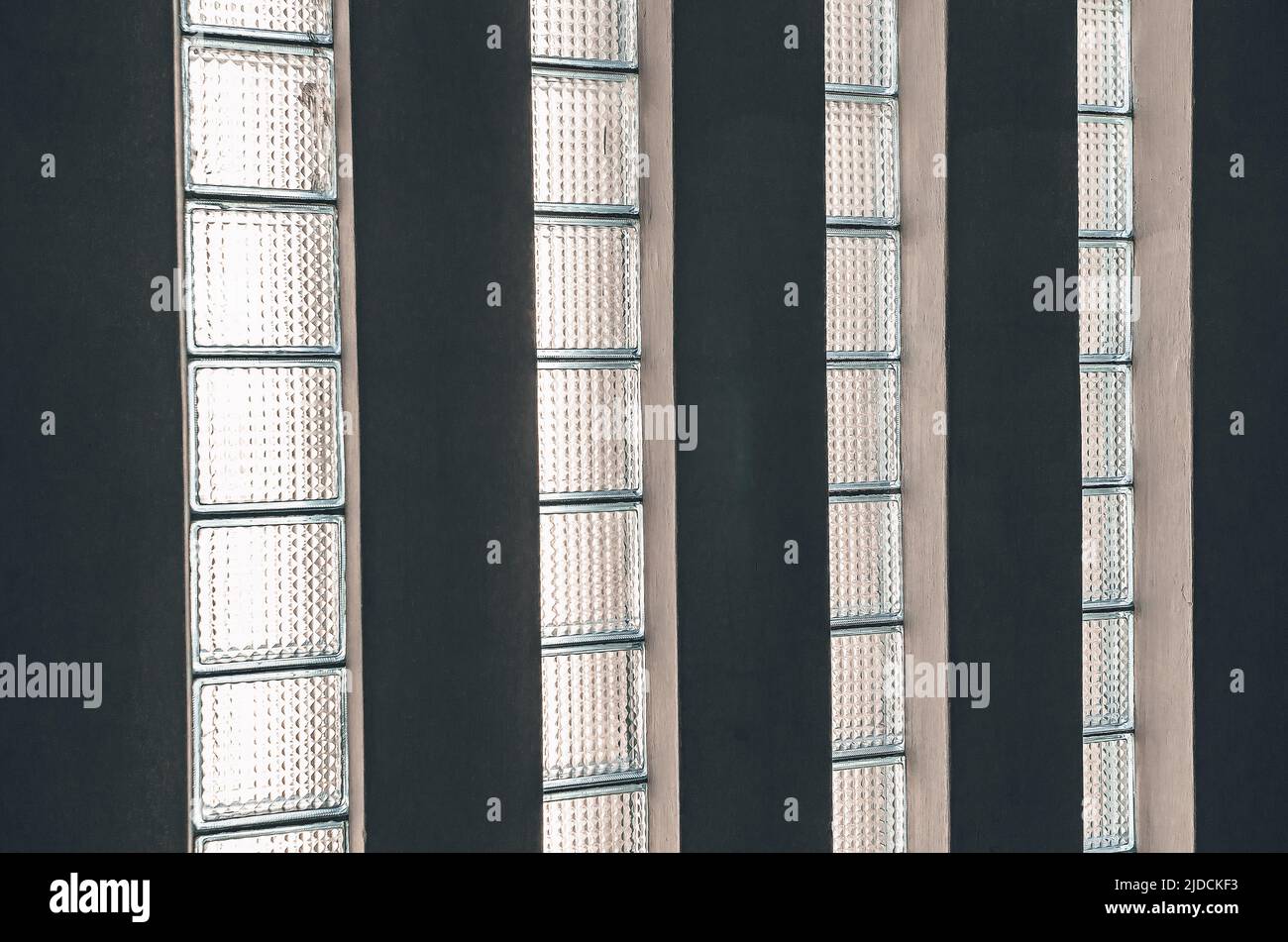 Old glass wall blocks in wall of a Soviet-style house. Scattered light ...