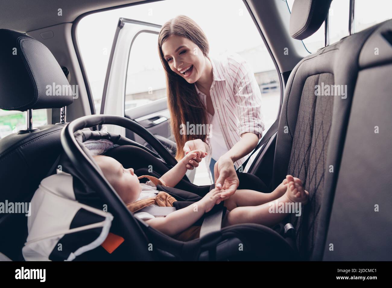 Portrait of positive cheerful lady hold arms cute adorable baby sitting ...