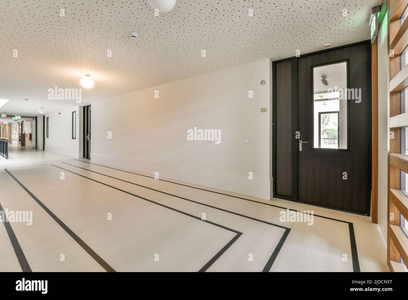 A compact light corridor with wooden walls and tiled floor Stock Photo ...
