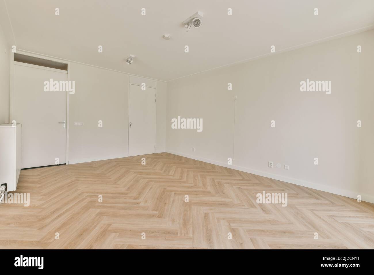 Spacious bright empty room with panoramic windows and parquet floor ...