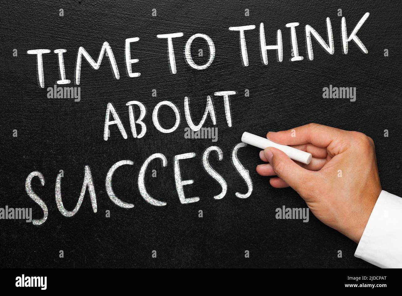Motivational phrase written on black chalkboard. Hand with chalk Stock ...