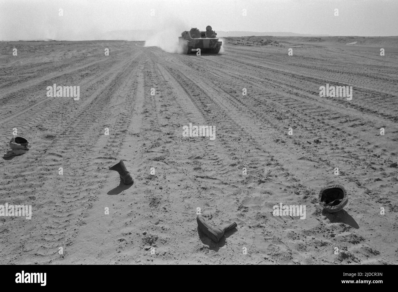 Boots and steel helmets lie in the sand of Sinai, in the background an ...