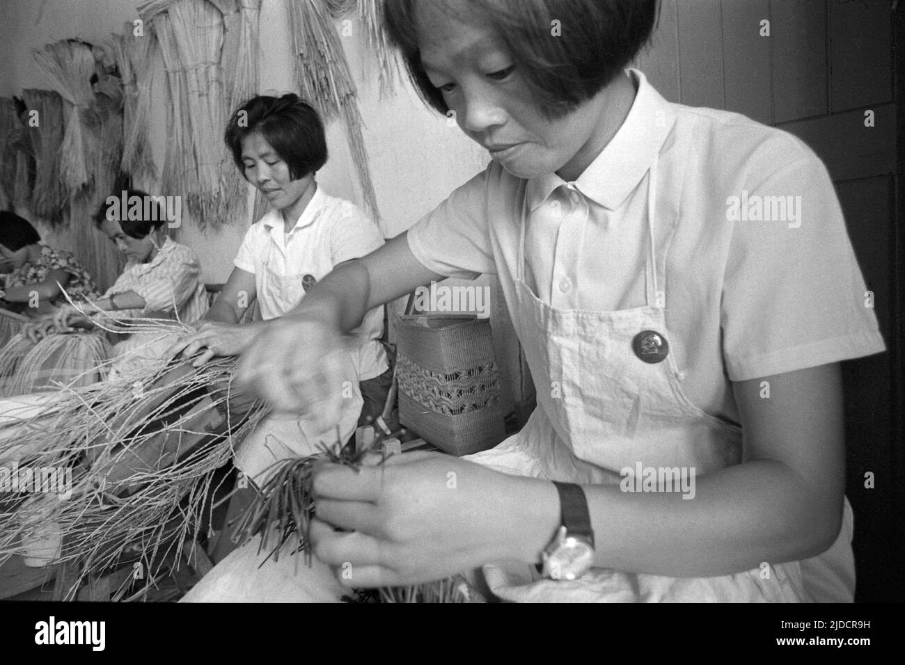 Chinese workers at work in a factory, they are braiding cords, July 29 ...