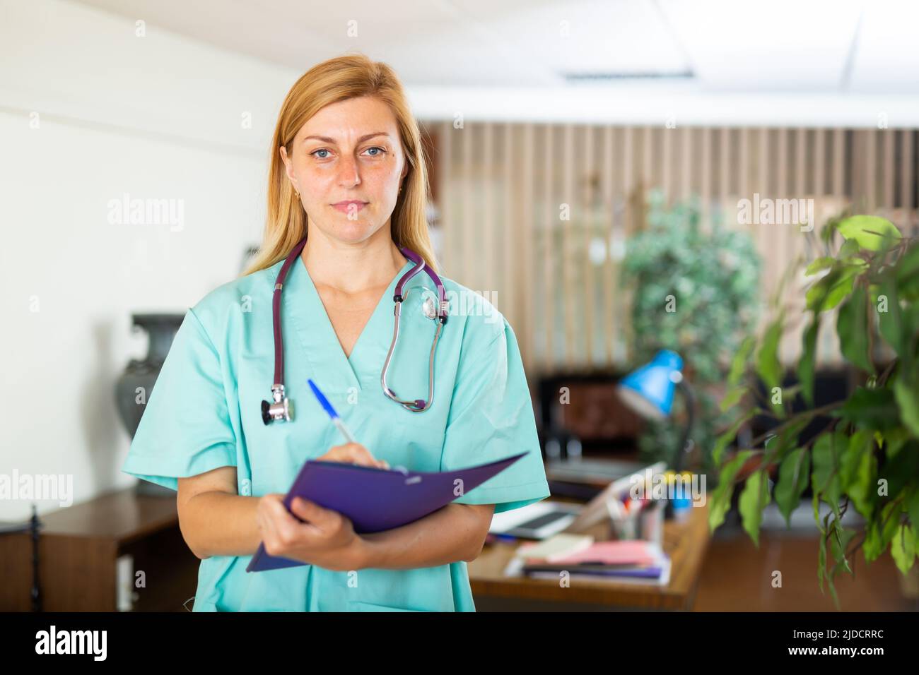 Female doctor assistant standing in medical office Stock Photo - Alamy