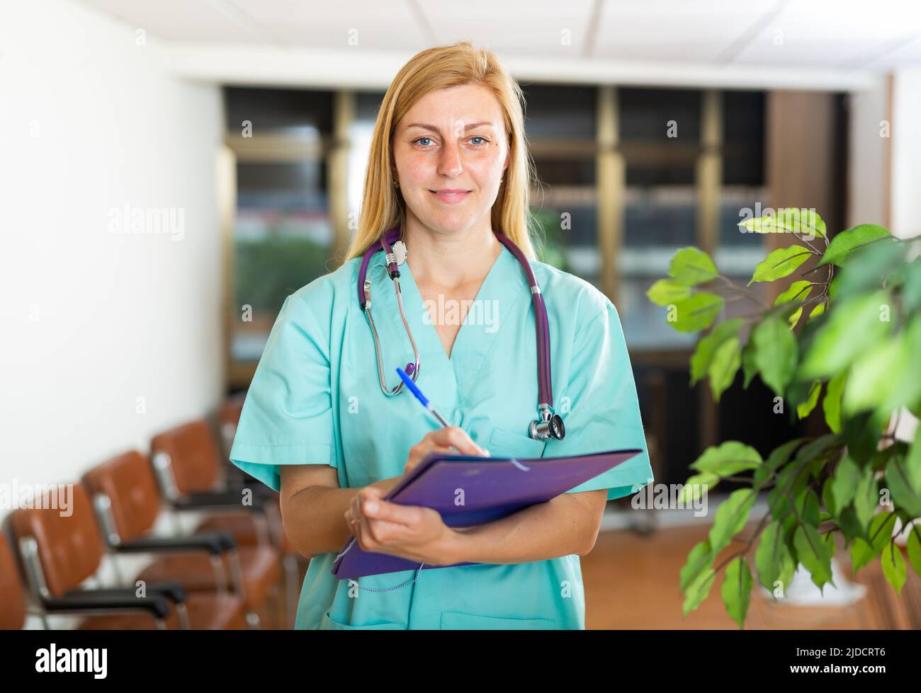 Female doctor assistant standing in medical office Stock Photo - Alamy