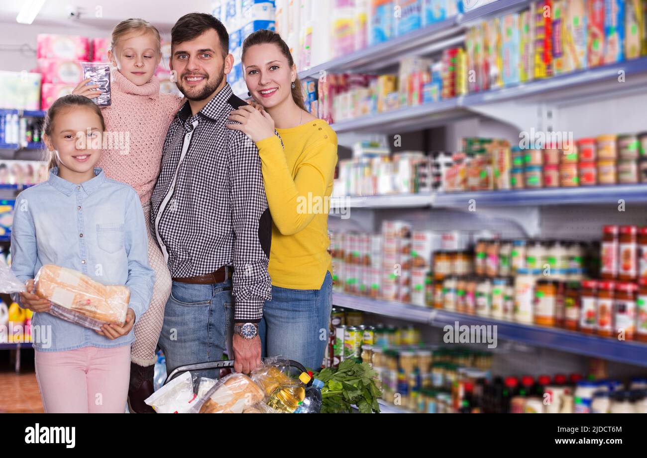 parents with girls with purchases during family shopping Stock Photo ...