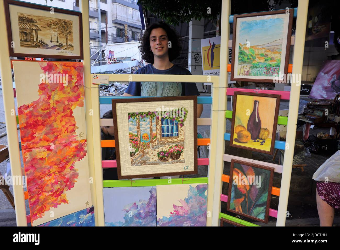 Beirut, Lebanon. 19th June, 2022. An artist stands at his art booth ...
