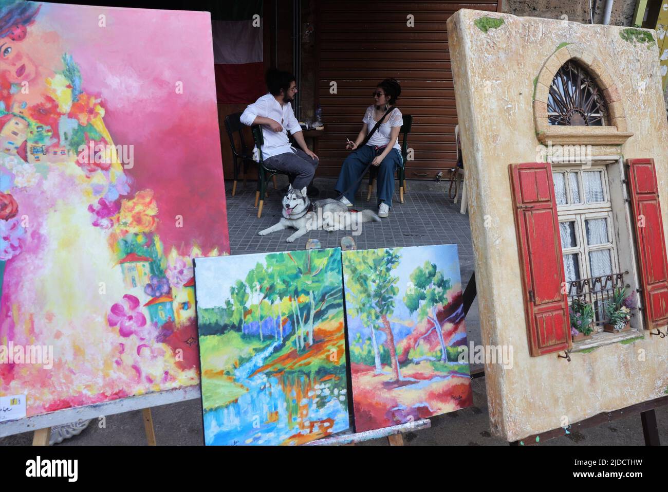 Beirut, Lebanon. 19th June, 2022. People sit and chat behind an art ...