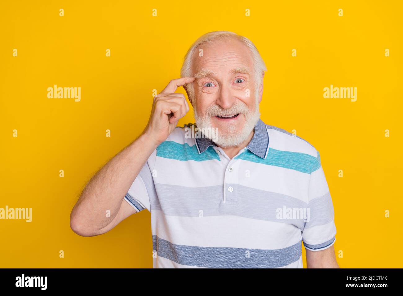 Portrait of attractive cheerful grey haired man touching temple making ...