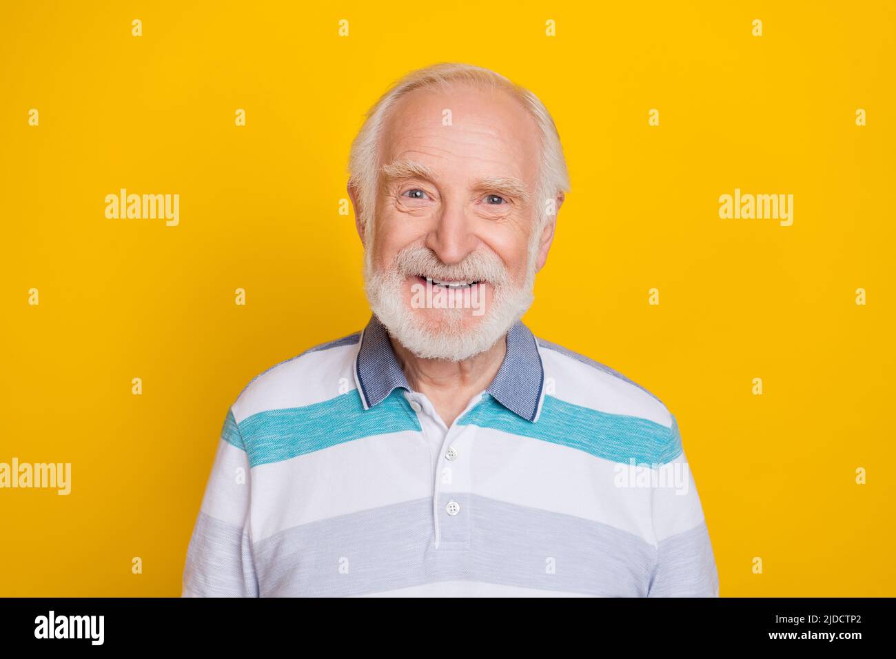 Portrait of attractive cheerful grey haired man smiling friendly ...