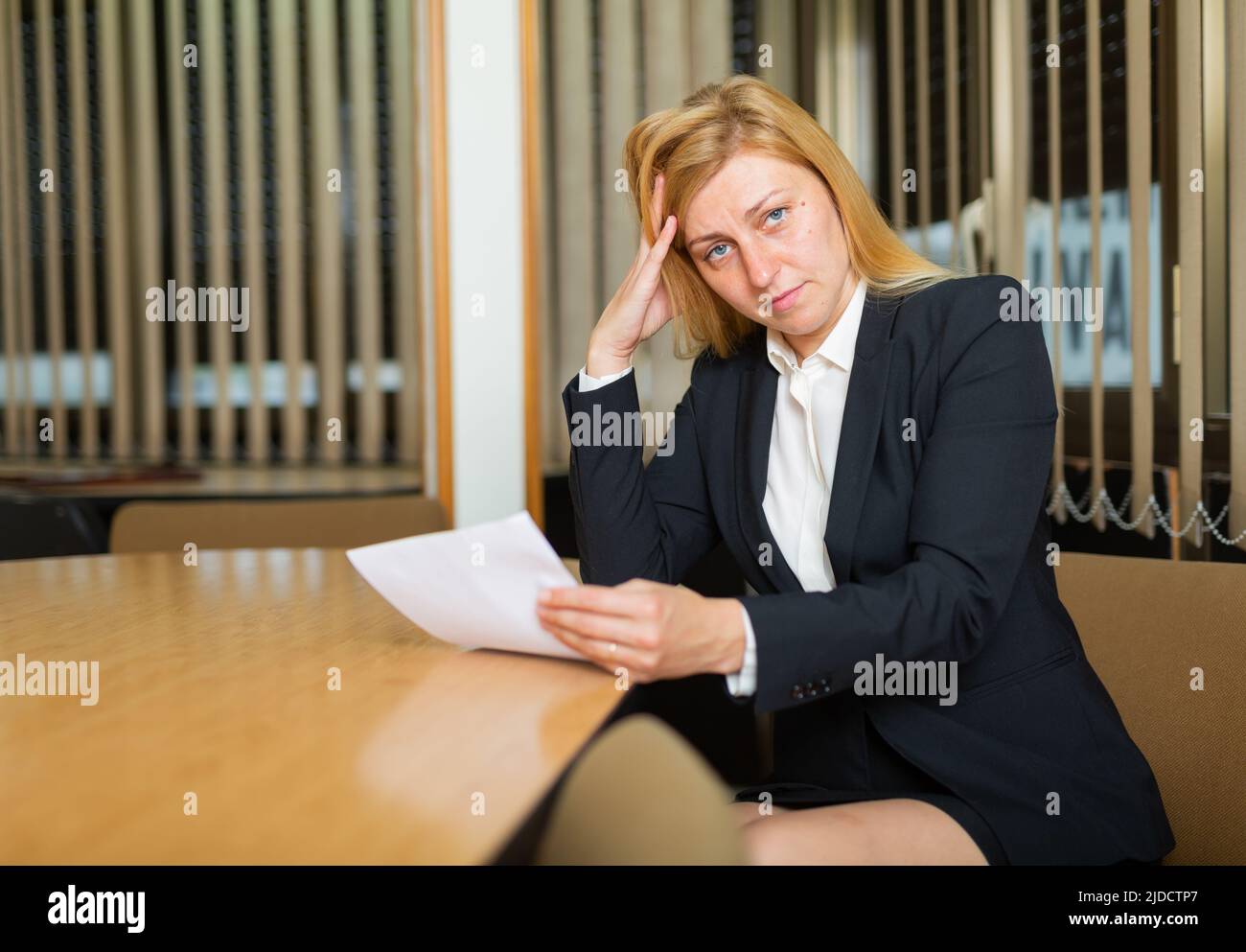 Upset female writing resignation letter Stock Photo - Alamy