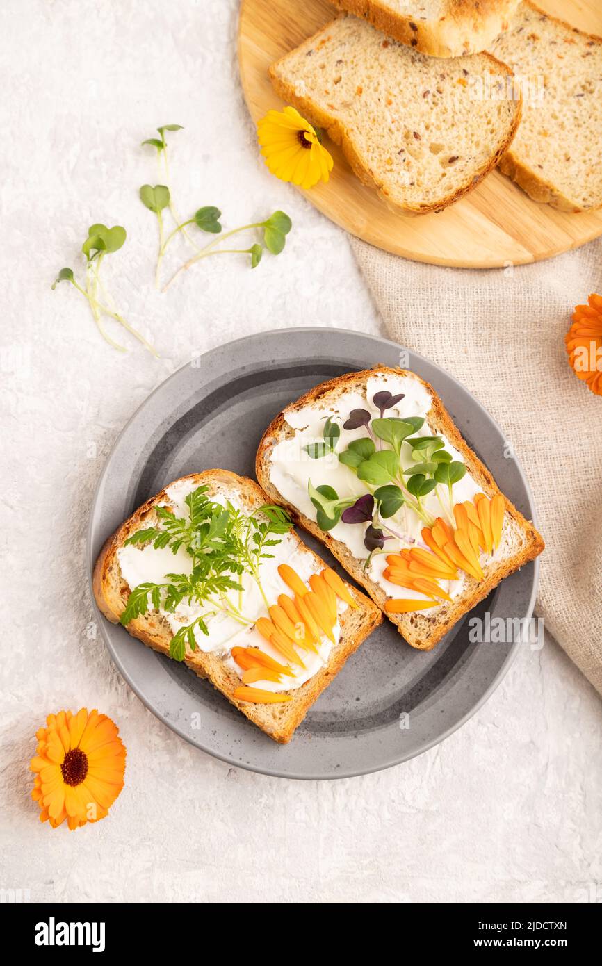 White bread sandwiches with cream cheese, calendula petals and ...