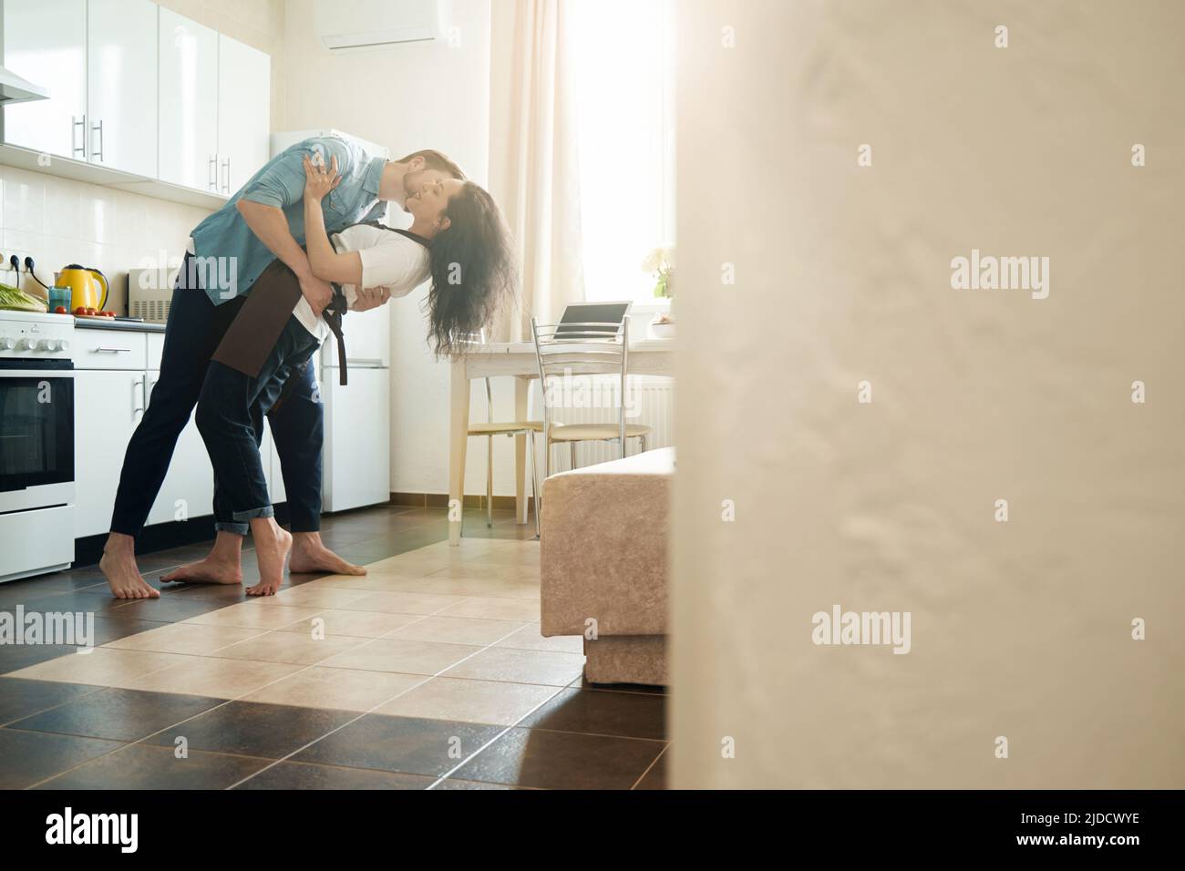 Passionate guy and his beloved woman in kitchen Stock Photo - Alamy