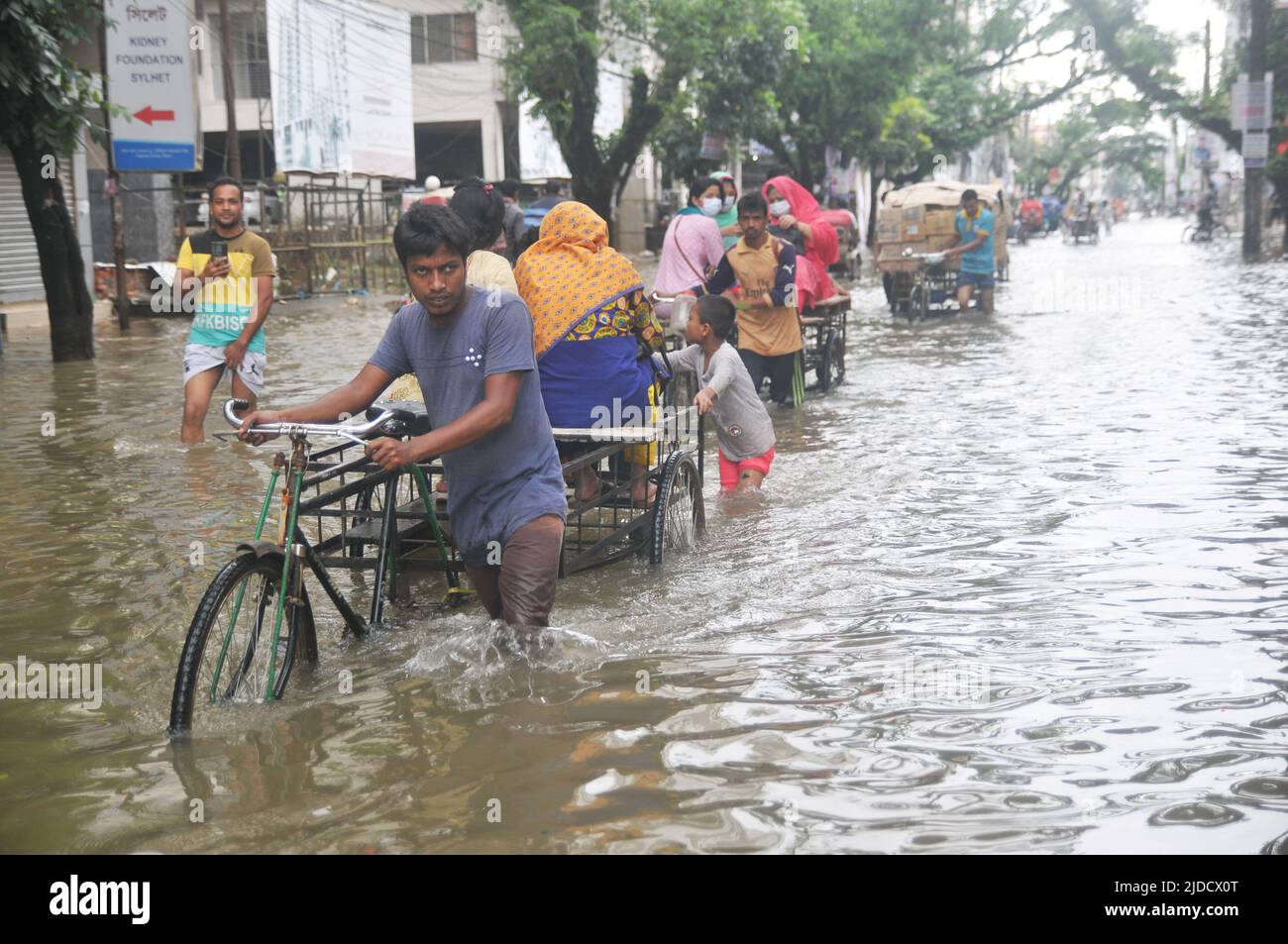 Sylhet, Bangladesh. 20th June 2022. People traveling in rickshaws during floods. The worst ...