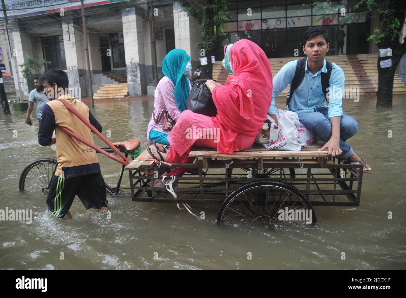 Sylhet, Bangladesh. 20th June 2022. People traveling in rickshaws during floods. The worst ...