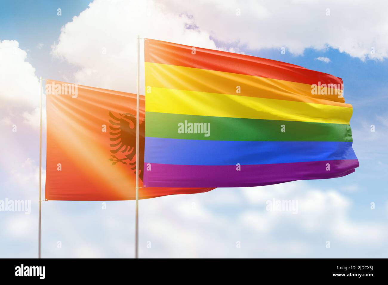 Sunny blue sky and flags of lgbt and albania Stock Photo - Alamy