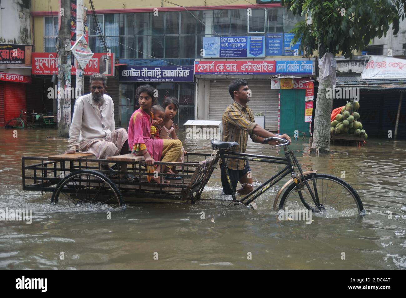Sylhet, Bangladesh. 20th June 2022. People traveling in rickshaws during floods. The worst ...