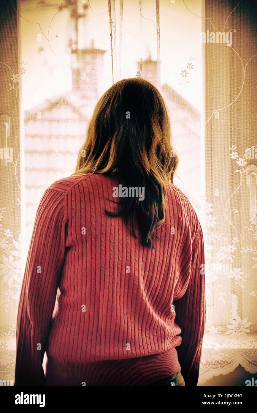 brunette girl looking out of a window, back side Stock Photo - Alamy