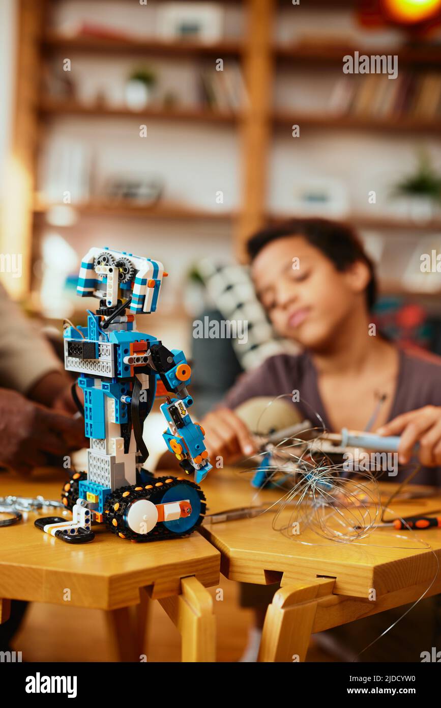 A smart African-American boy recording himself for a vlog and showing ...