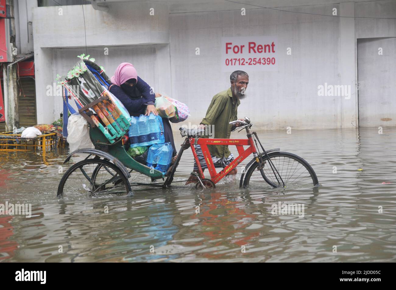Sylhet, Bangladesh. 20th June 2022. People traveling in rickshaws during floods. The worst ...