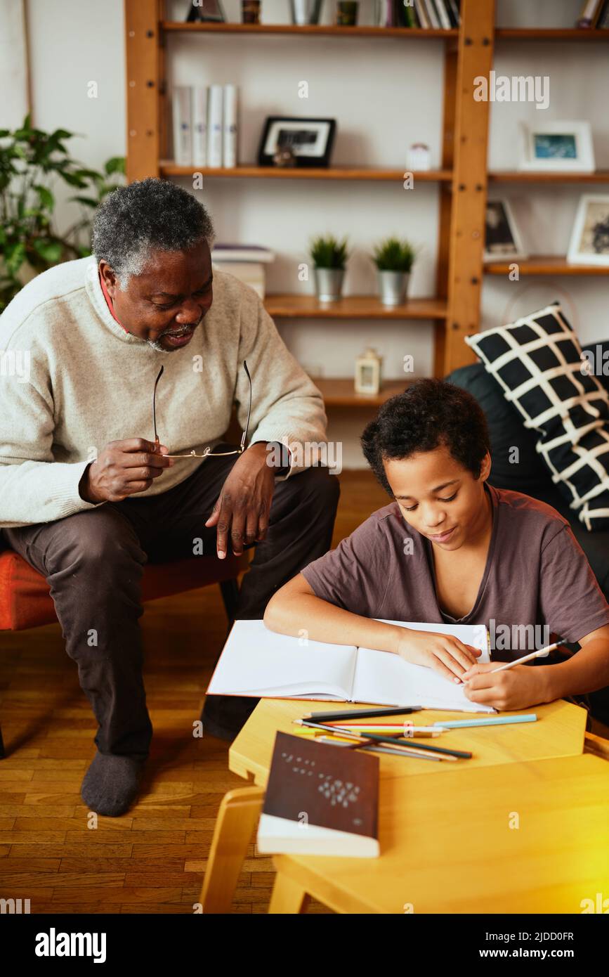 Grandfather helping child homework hi-res stock photography and images ...