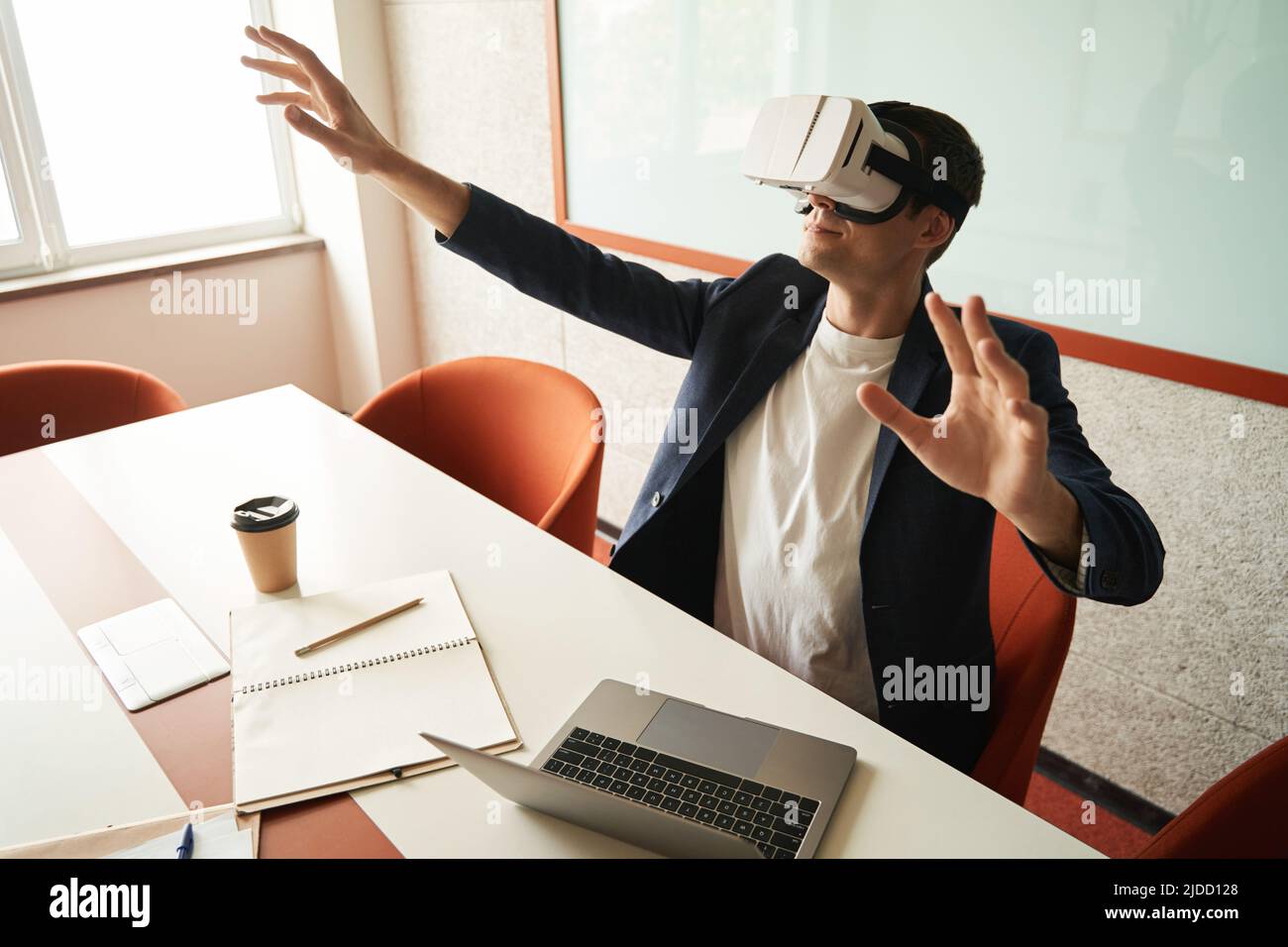 Office clerk looking at virtual reality simulation through headset ...