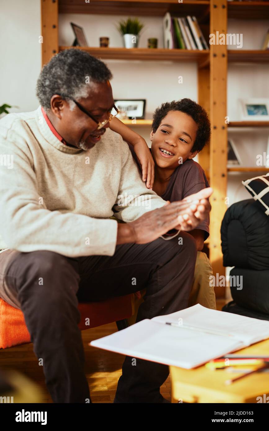 Proud grandfather clapping his hands and congratulating his grandson ...