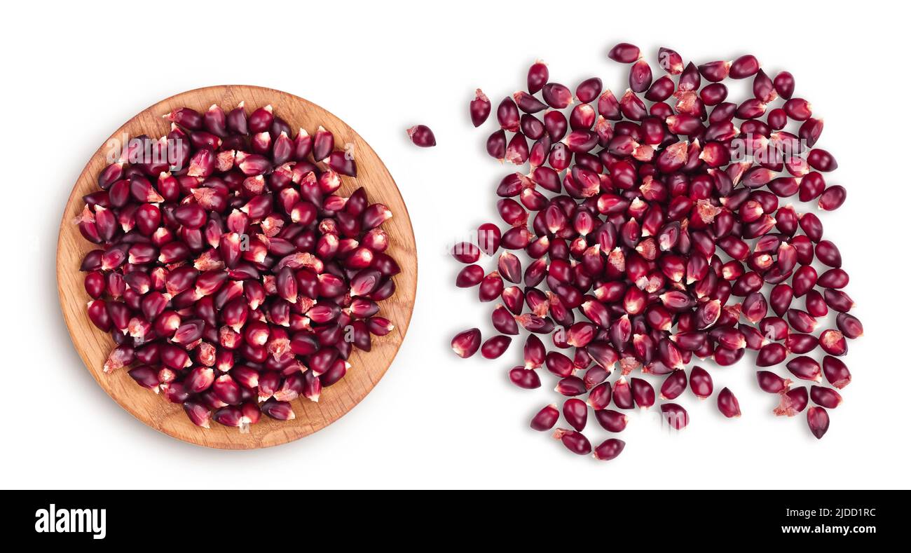 Purple corn or maize seeds in wooden bowl isolated on white background ...