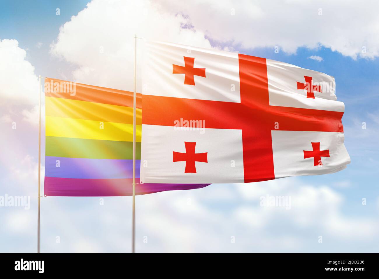 Sunny blue sky and flags of lgbt and georgia Stock Photo - Alamy