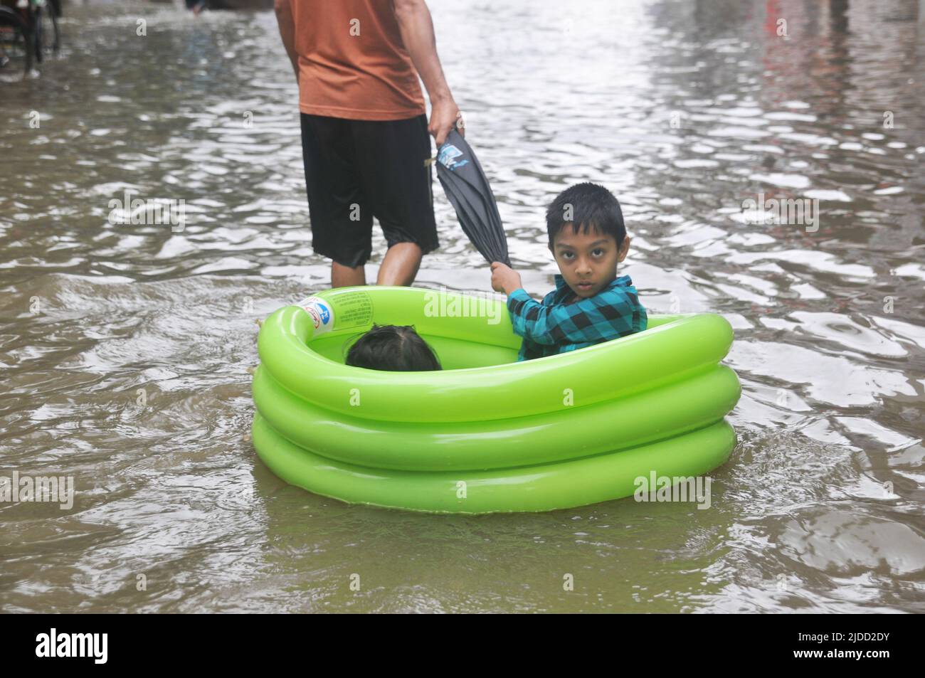Sylhet, Bangladesh. 20th June 2022. Children float in a blown up tub ...