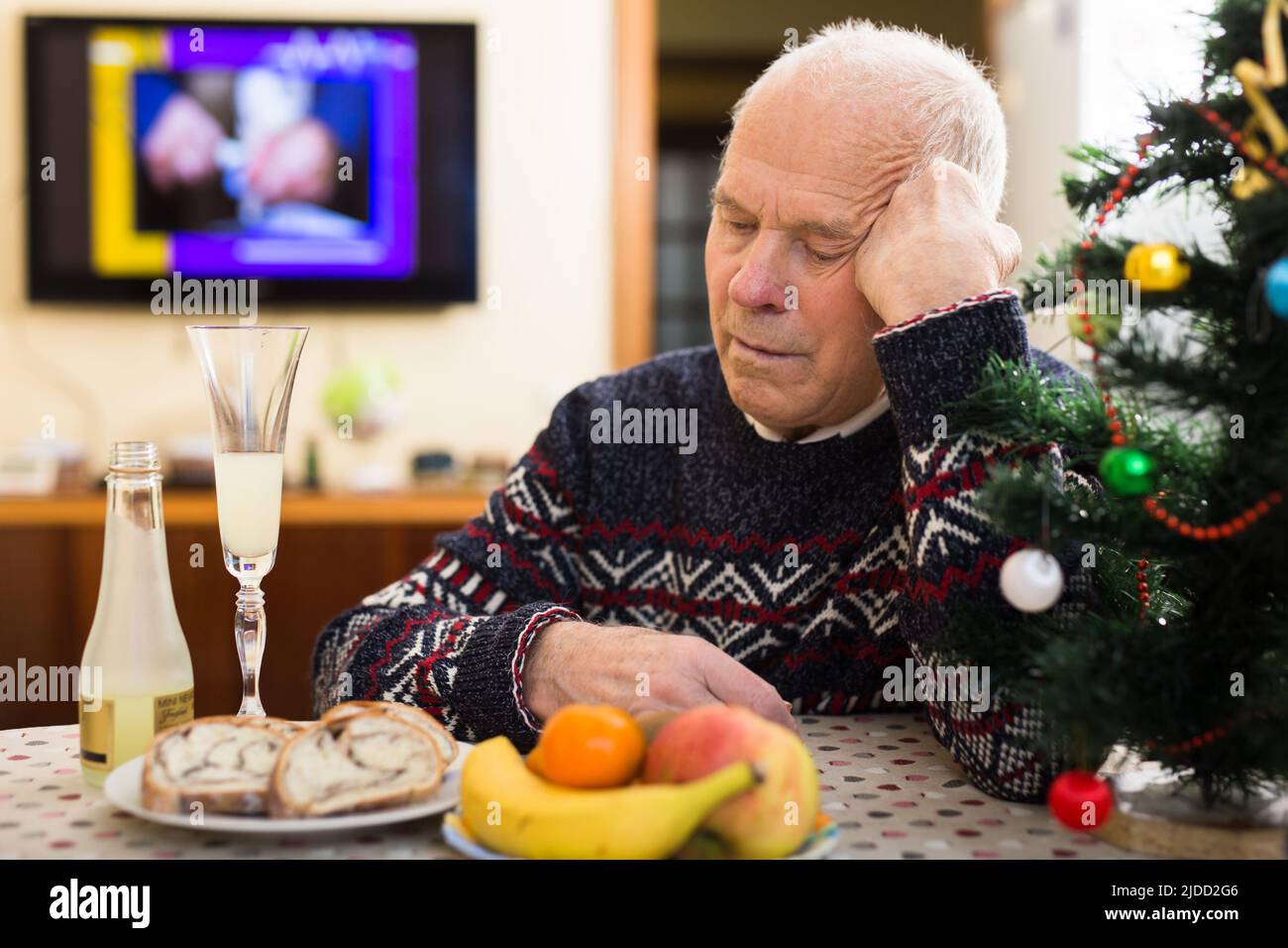 Sad older man celebrating New Year alone during pandemic Stock Photo ...