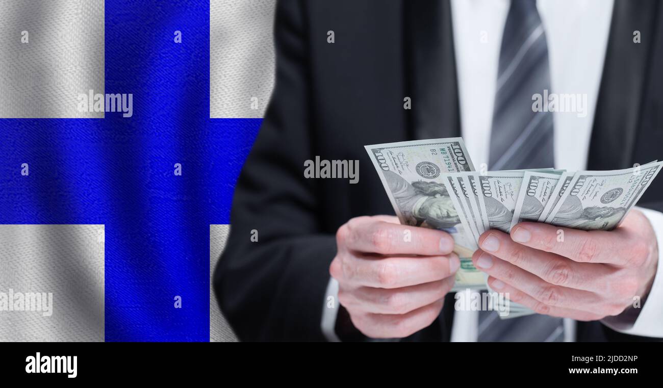 Hands holding dollar money on flag of Finland Stock Photo - Alamy