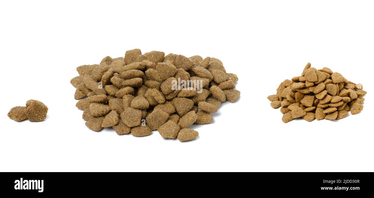 triangular pieces of animal food on a white background. Pile of ...