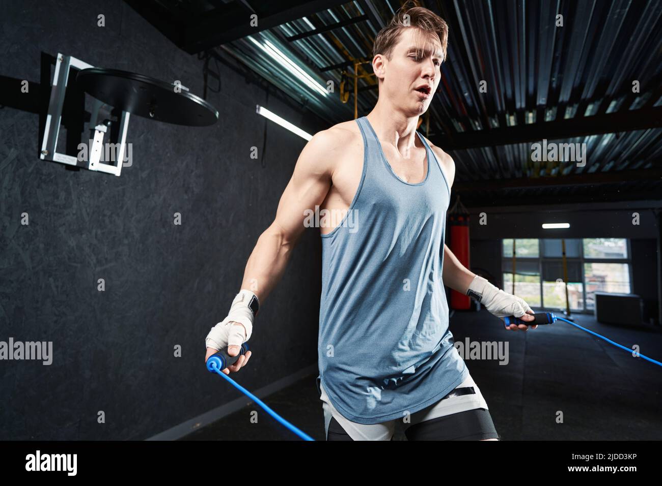 Focused muscular male athlete performing cardio exercise Stock Photo ...