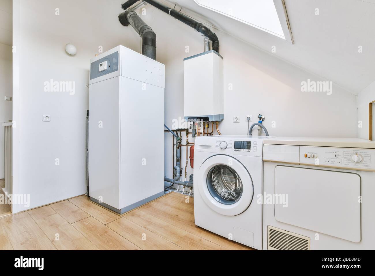 White wardrobe with washing machine in light room at home Stock Photo ...