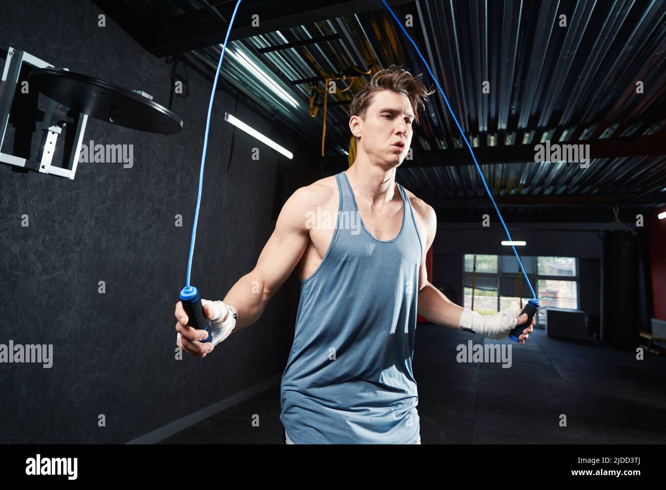 Focused young athletic male doing cardio training Stock Photo - Alamy