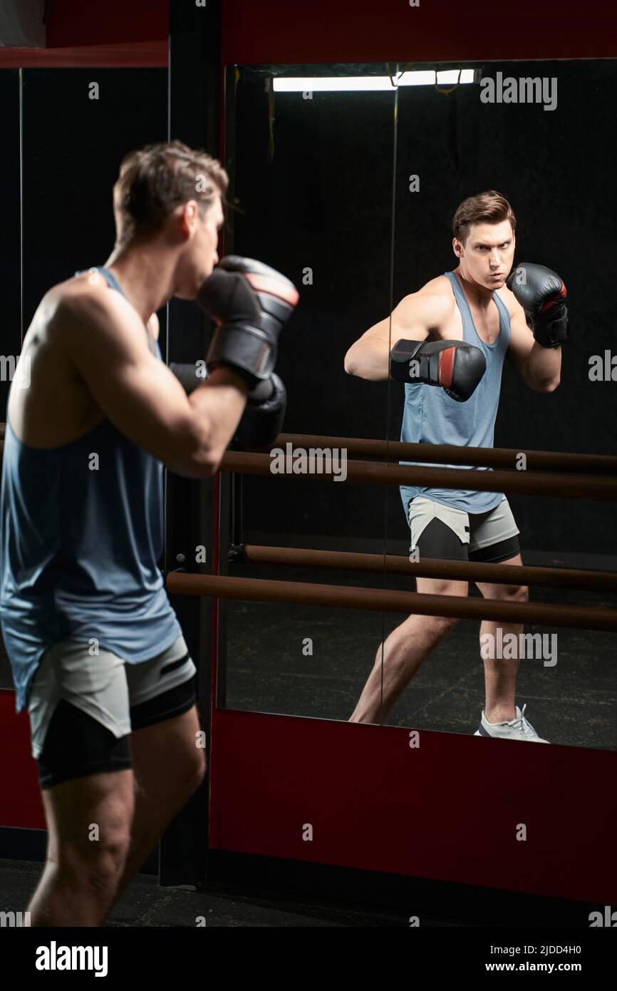 Young boxer throwing punches during training session Stock Photo - Alamy