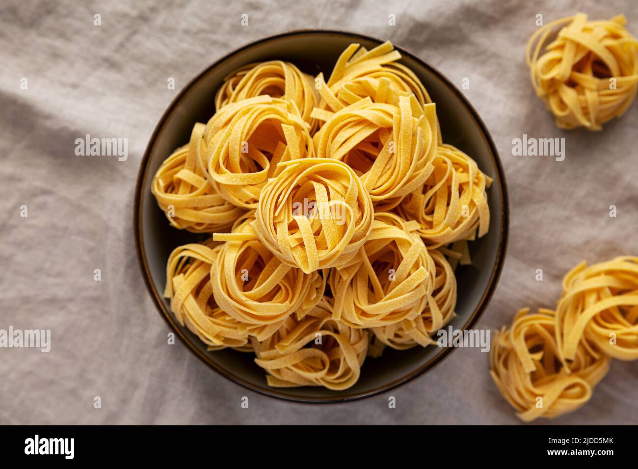 Homemade Organic Dry Tagliatelle Pasta in a Bowl, top view. Flat lay ...