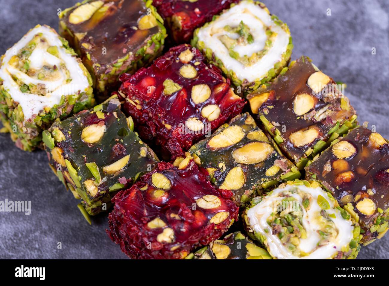 Turkish delight on a dark background. Traditional Turkish delicacies ...