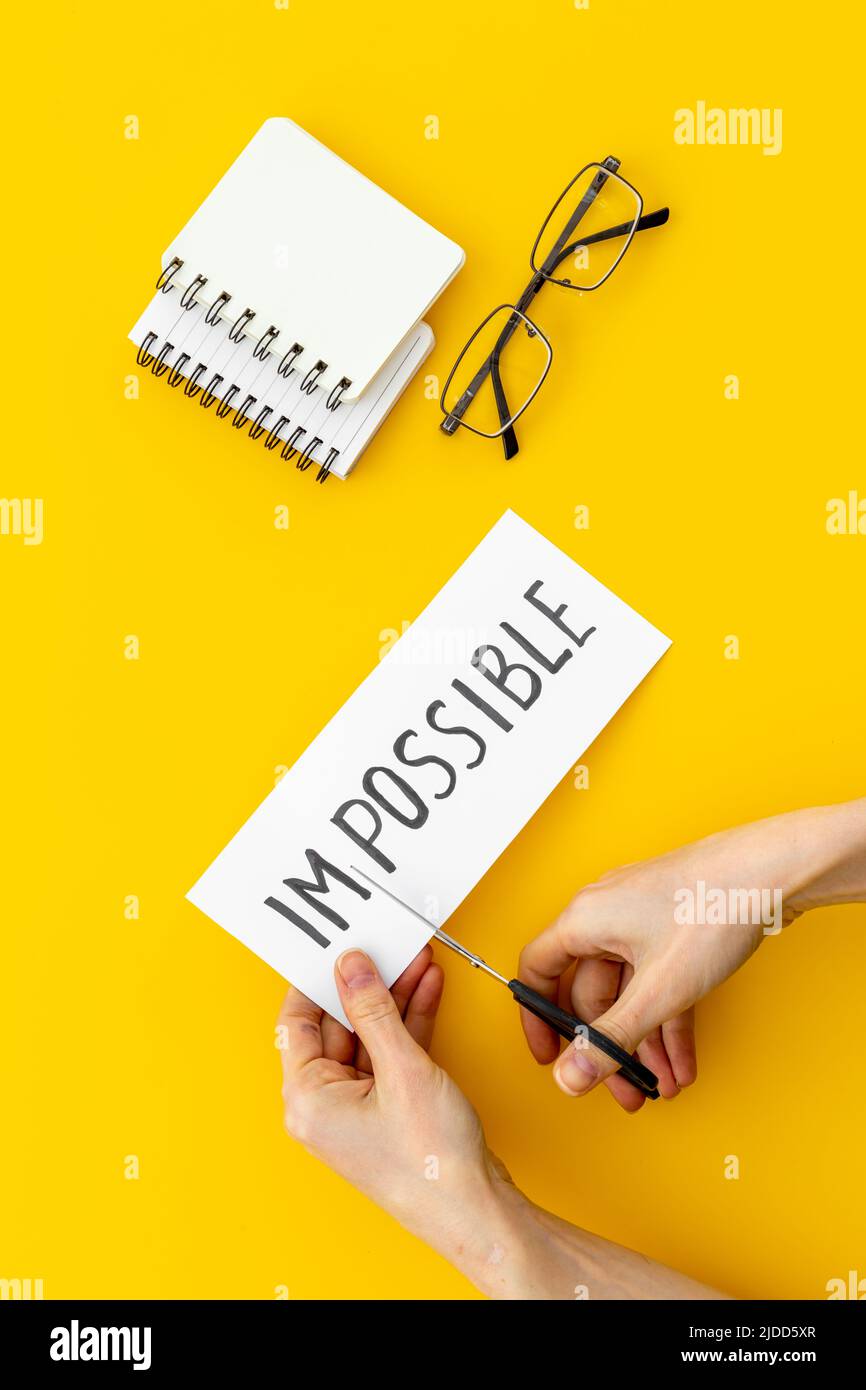 Hands changing word impossible to possible with scissors. Selfmade ...