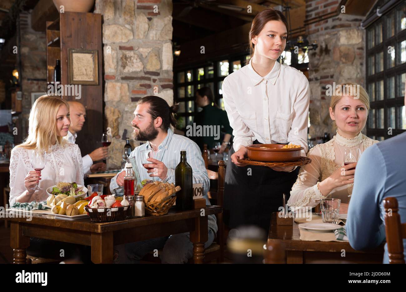 Positive waitress bringing order hi-res stock photography and images ...
