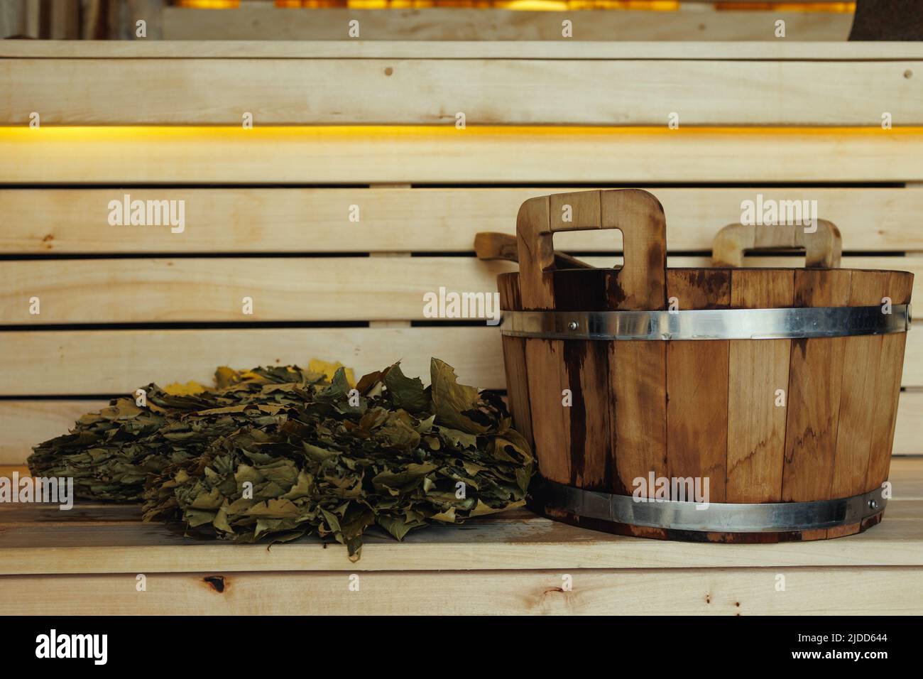 Bucket and broom for a bath on wooden planks of a bench in a sauna ...
