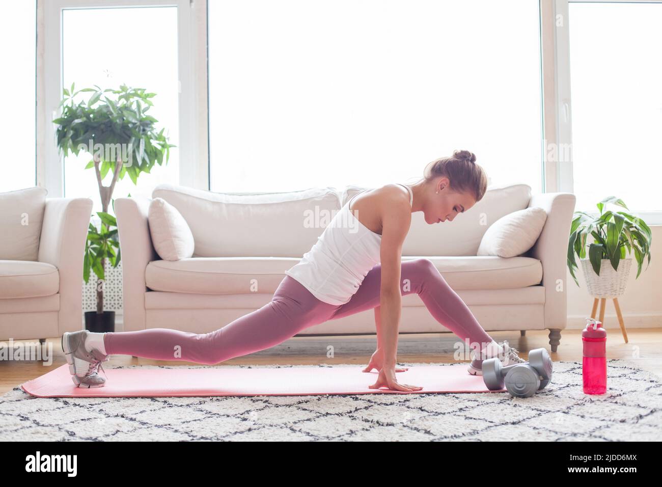 Attractive woman doing fitness stretching exercises at home. Sport ...