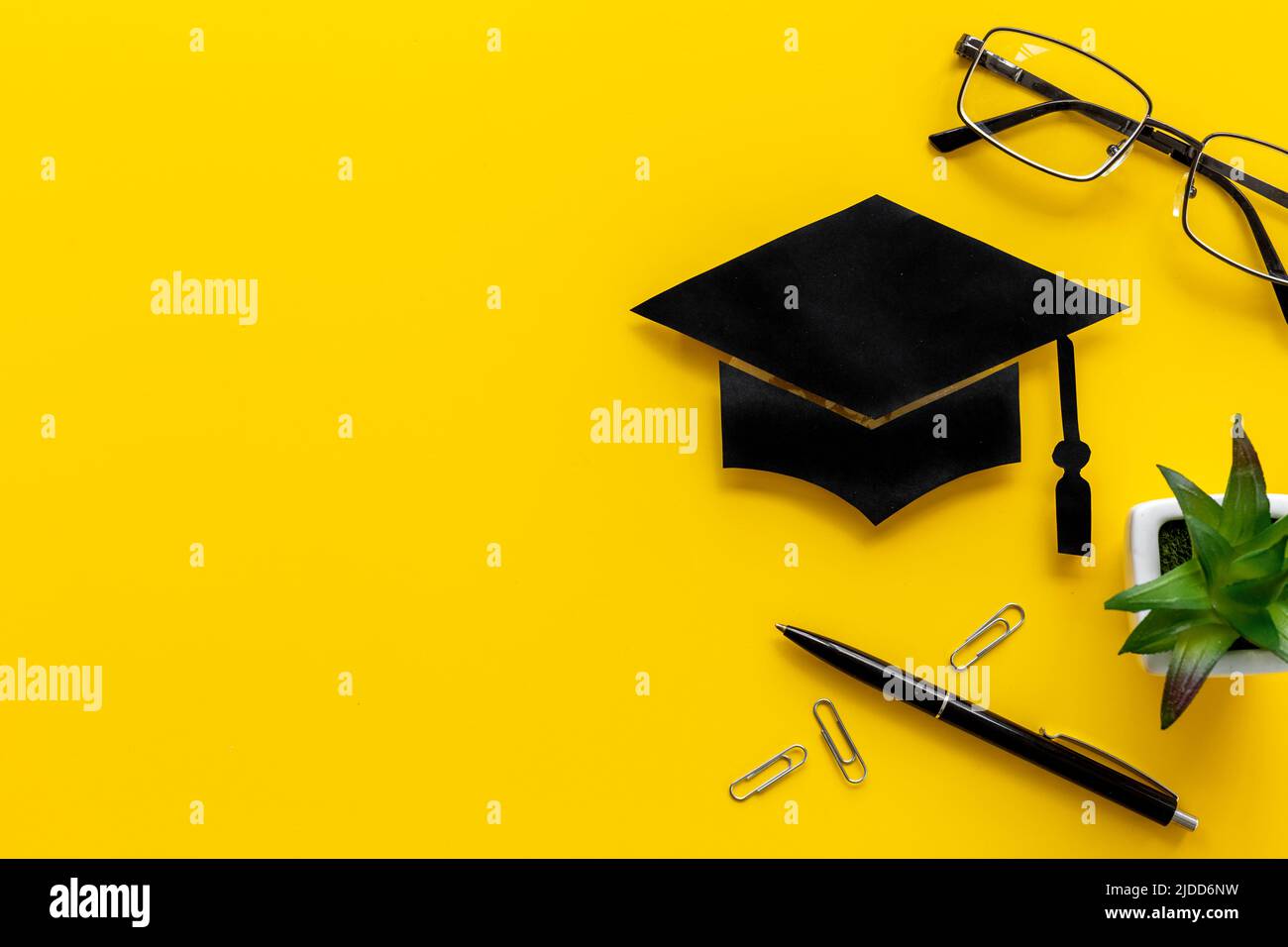 Graduation hat on students table. Masters or Bachelors degree concept ...