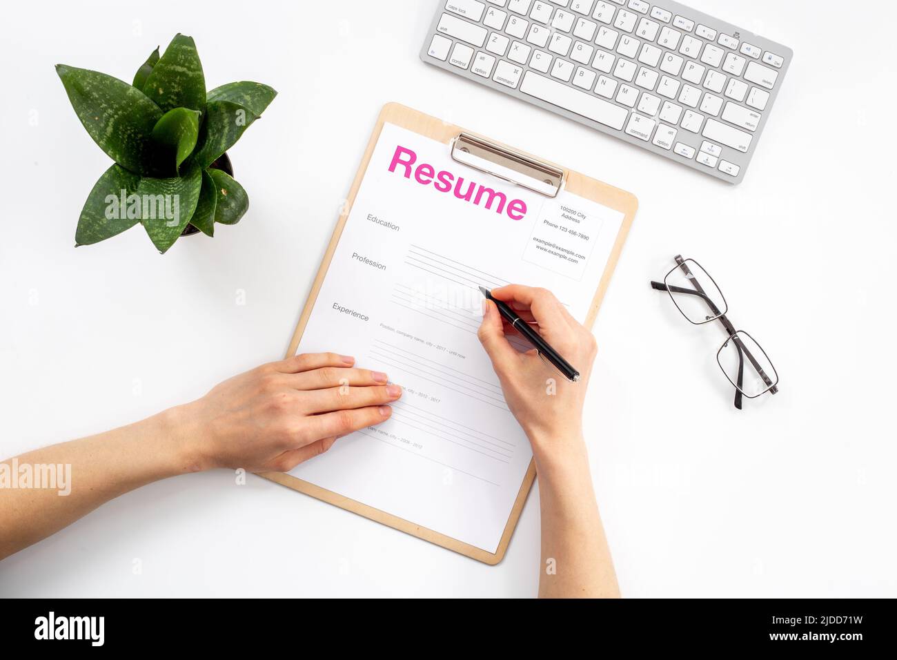 Employer reviews resume application form on office table Stock Photo ...