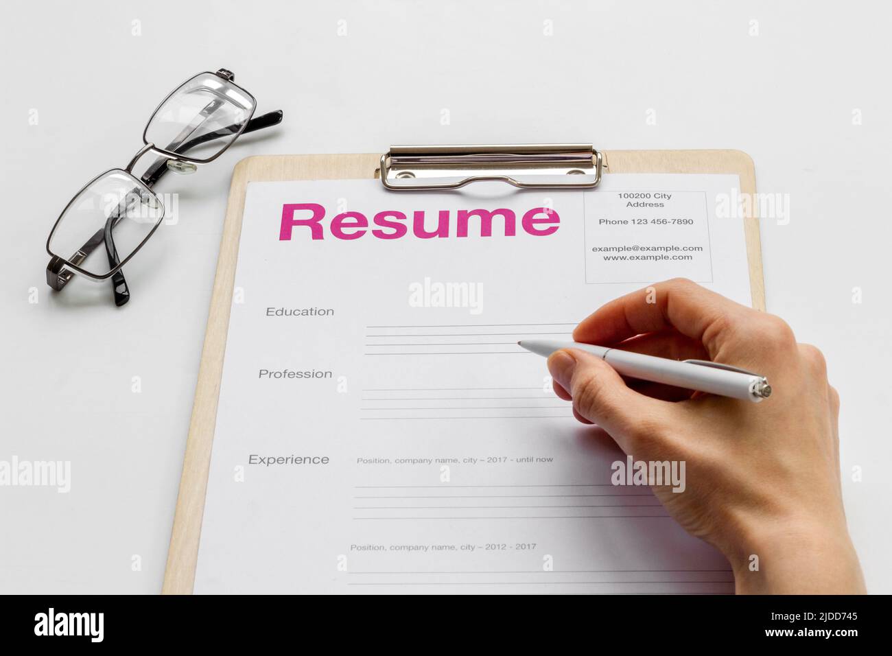 Employer reviews resume application form on office table Stock Photo ...